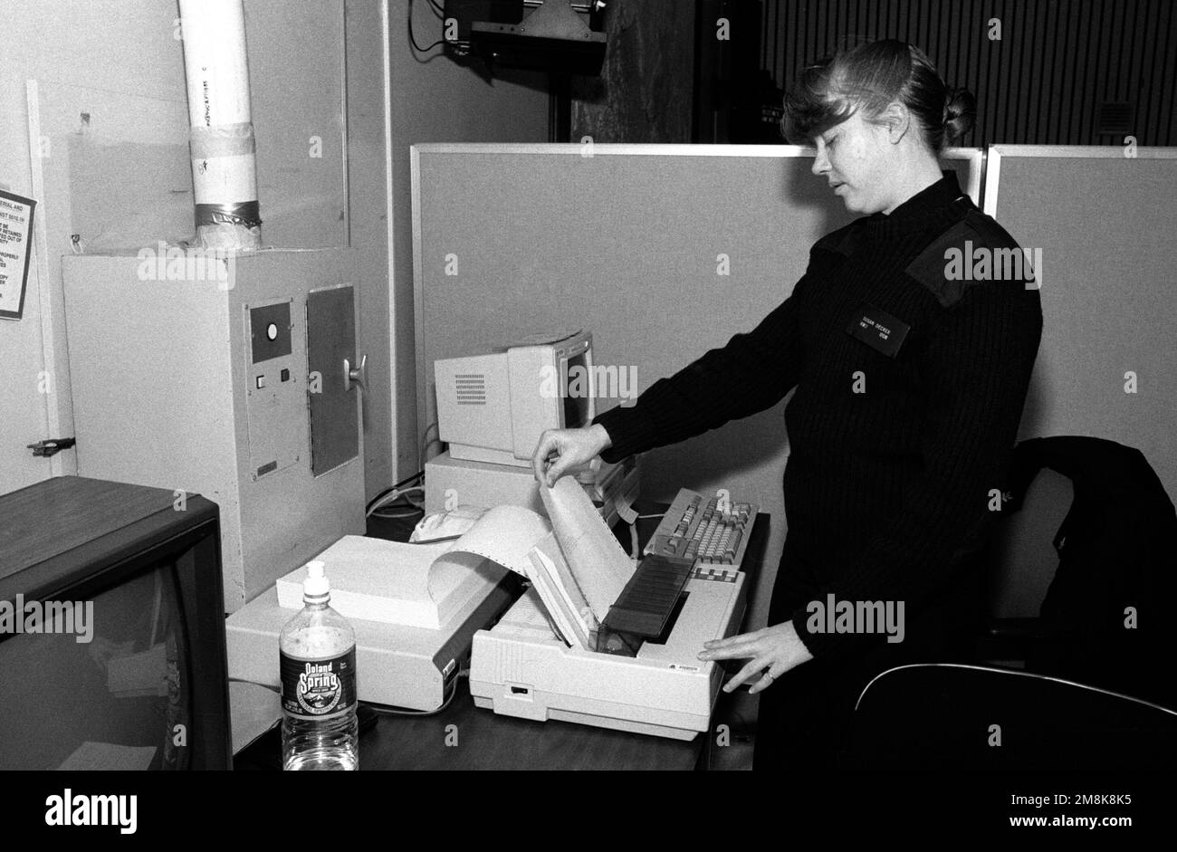 Radioman Second Class (RM2) Susan Decker pulls message traffic for the ...