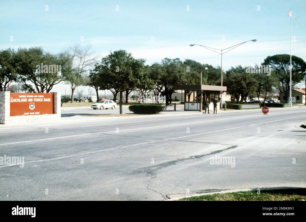 A long-range view of the main gate and base sign. Base: Lackland Air ...