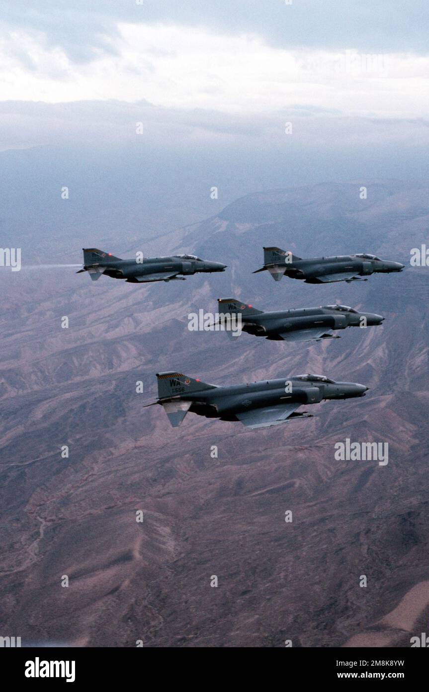 An aerial right side view of a four ship formation of USAF F-4G Phantom ...