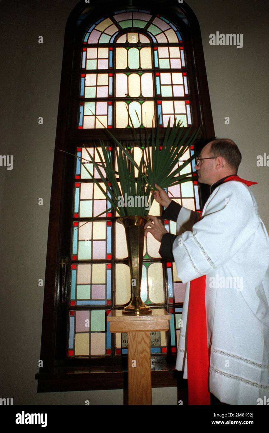 A chaplain arranges palm fronds at the Chapel of Hope in preparation ...