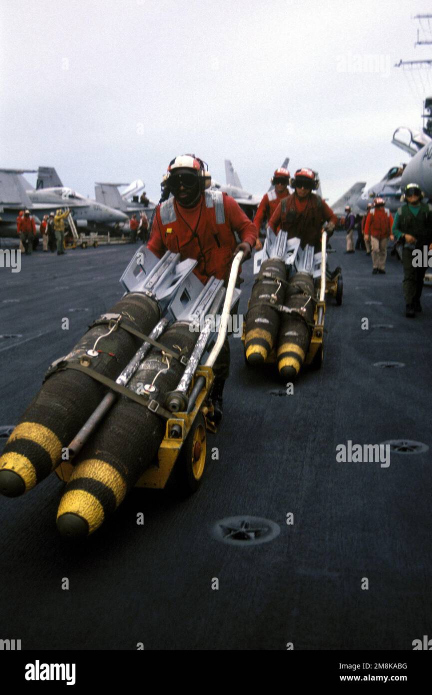 Aviation Ordnanceman Second Class (AO2) Darrell Thomas leads a crew ...