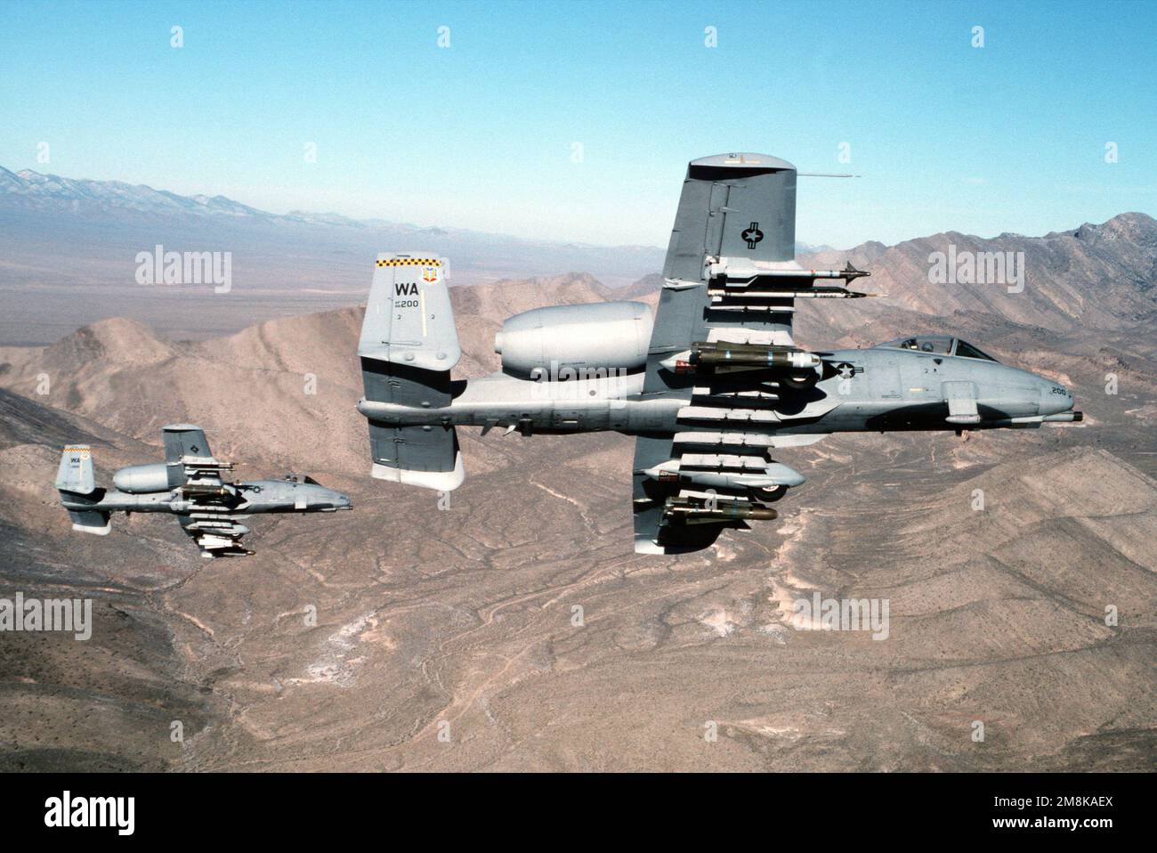 An air-to-air right underside view of a two ship formation of USAF A-10 ...