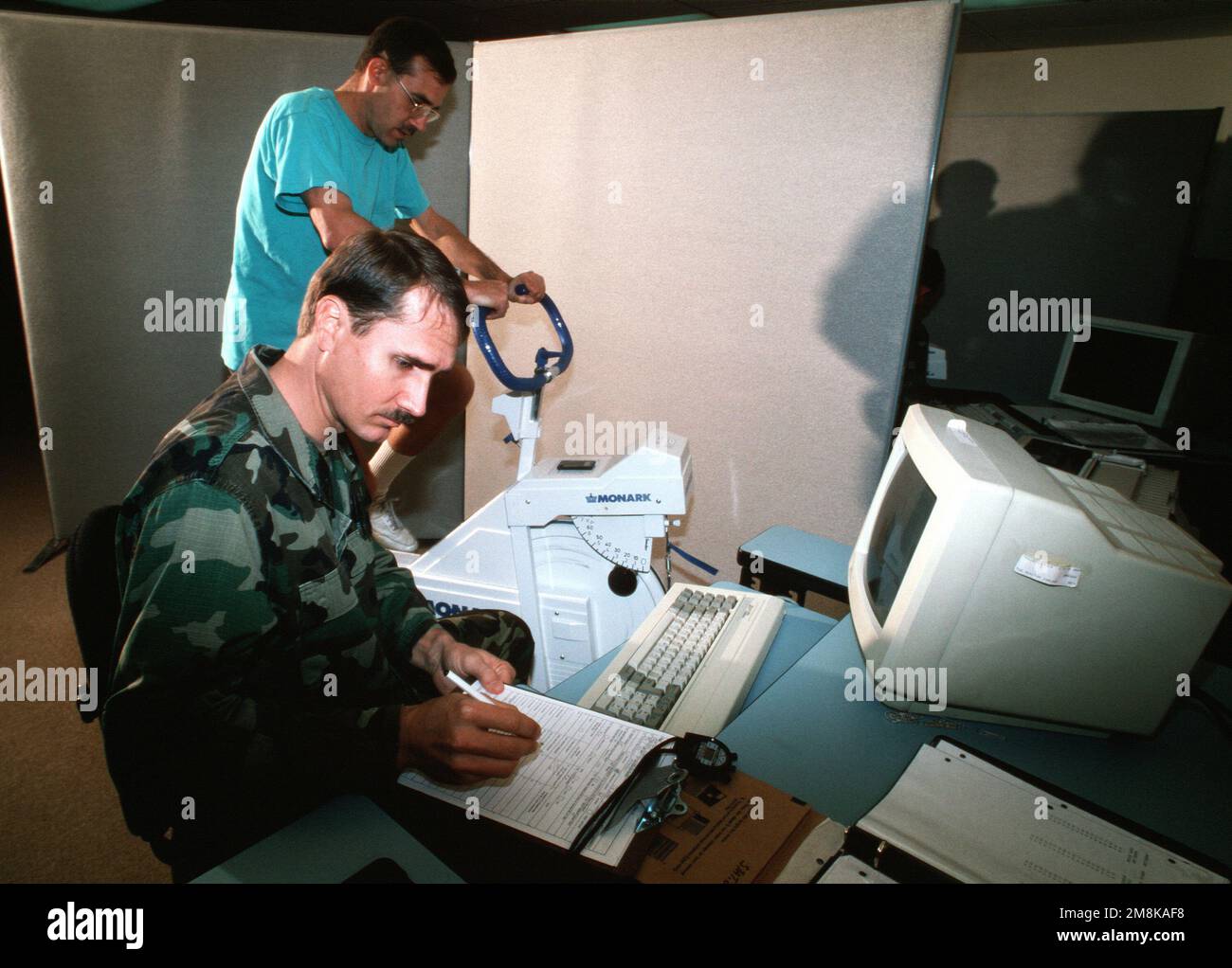 A USAF fitness monitor records the results of person taking the Air ...