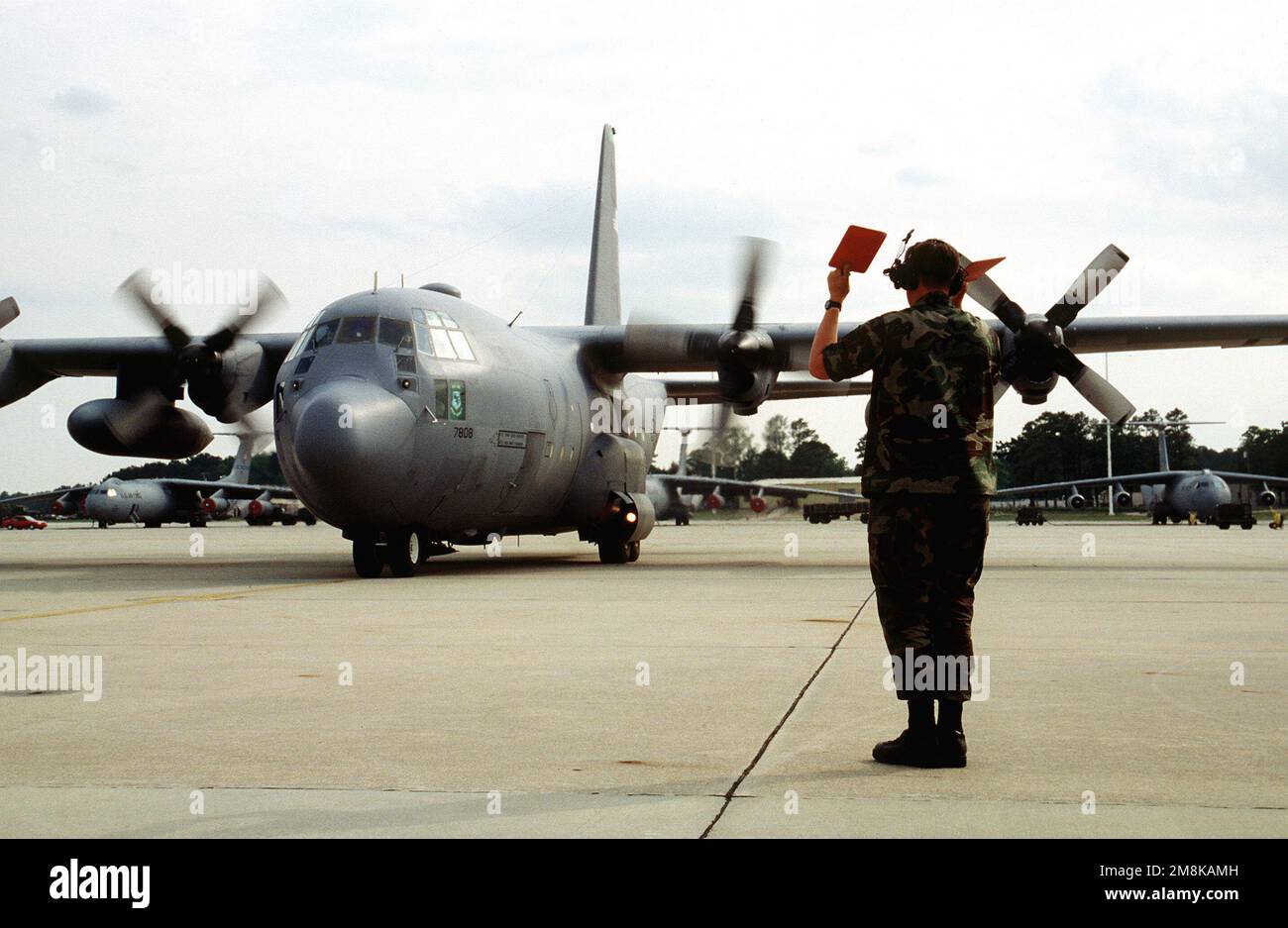 SENIOR AIRMAN Mike Audas directs a US Air Force C-130 Hercules cargo ...