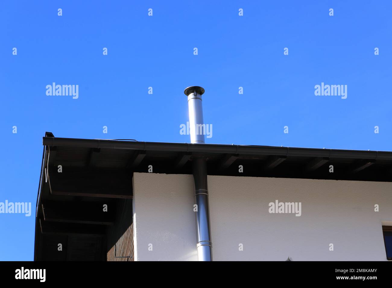 new stainless steel chimney on a house Stock Photo - Alamy