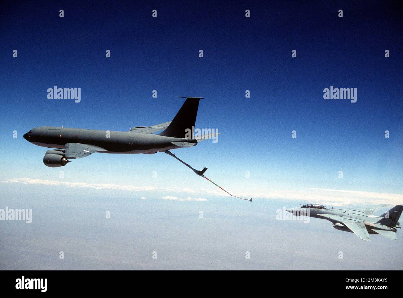 A side view of a KC-135 Stratotanker refueling an F-14 Tomcat from VF ...