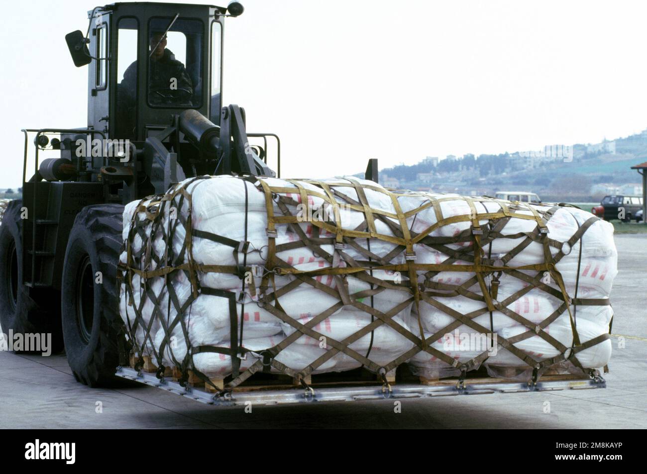 A forklift carrying a pallet of sacks of flour is driven to an awaiting ...