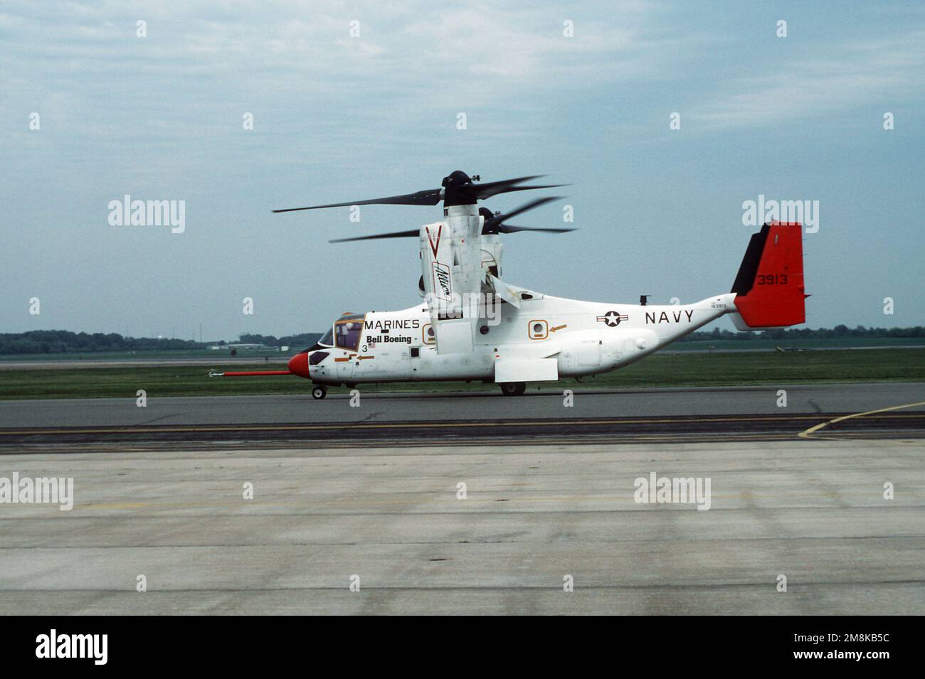 A left side view of a V-22 Osprey tilt-rotor test aircraft taxiing on ...