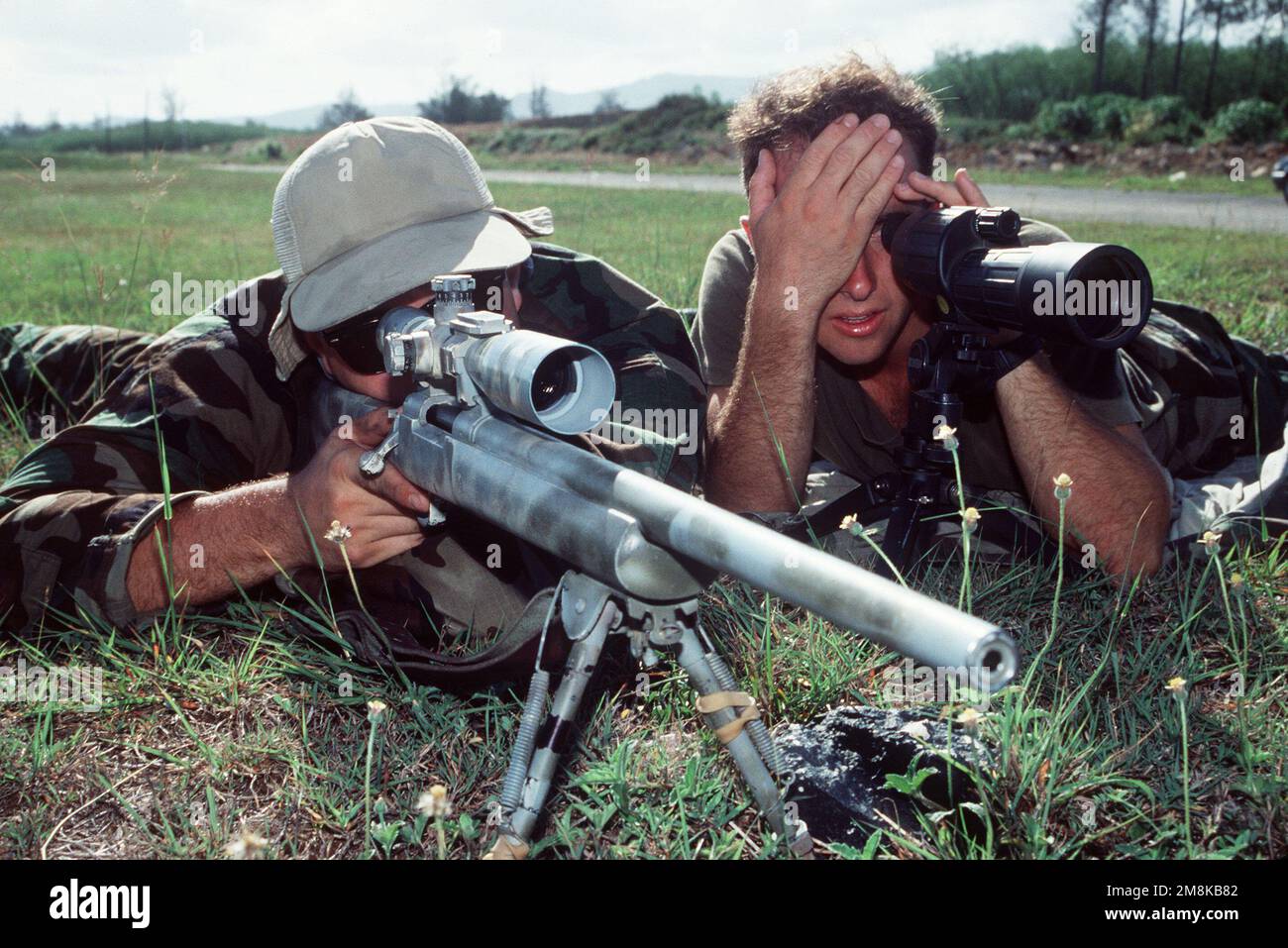 Sniper, Boatswain Mate Third Class (BM3) Todd Hubert is assisted by his ...