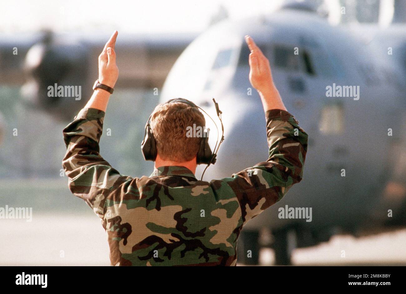 A head and shoulders shot of the back of a US Air Force crew chief as ...