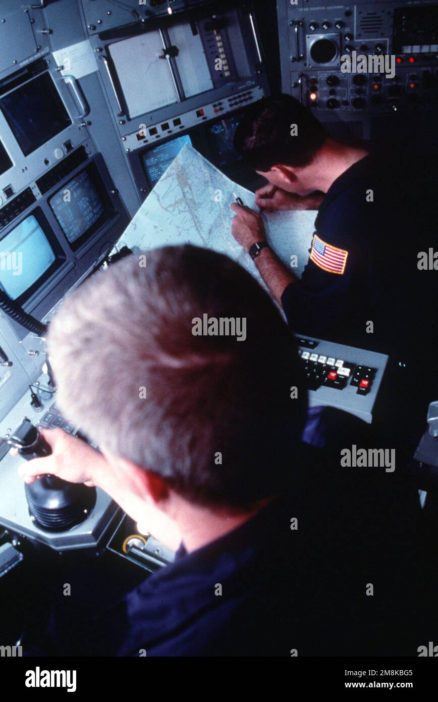 Machinist Mate First Class (MM1) Brett Jebia watches LT. CMDR. David ...