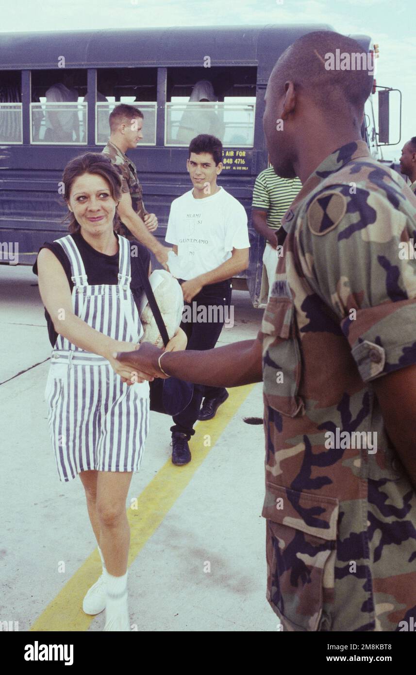 US Army SPC Keller shakes hands with Cuban migrants as they board a ...
