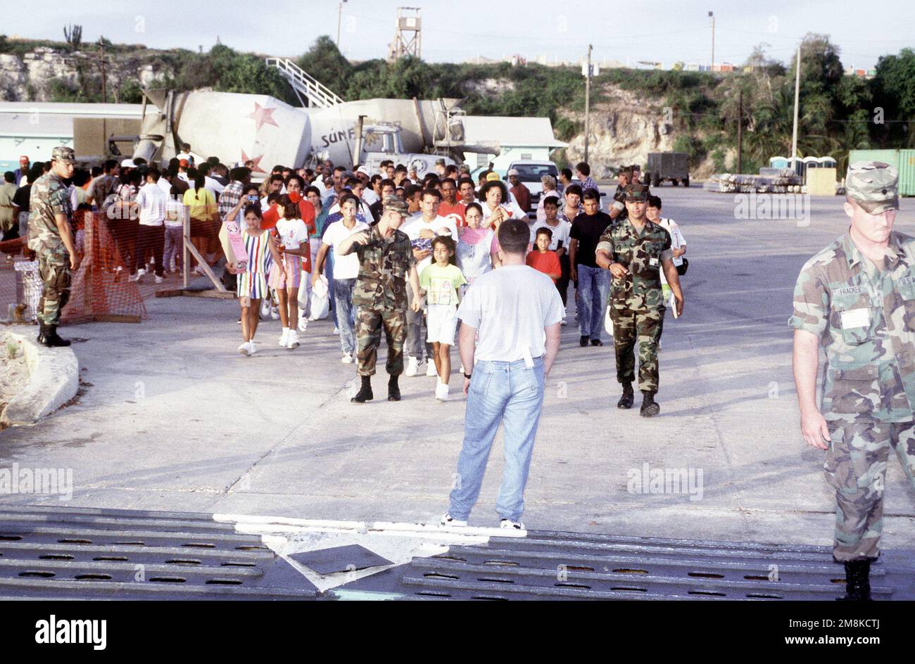 Cuban immigrants walk to a US Navy landing craft that will ferry them ...