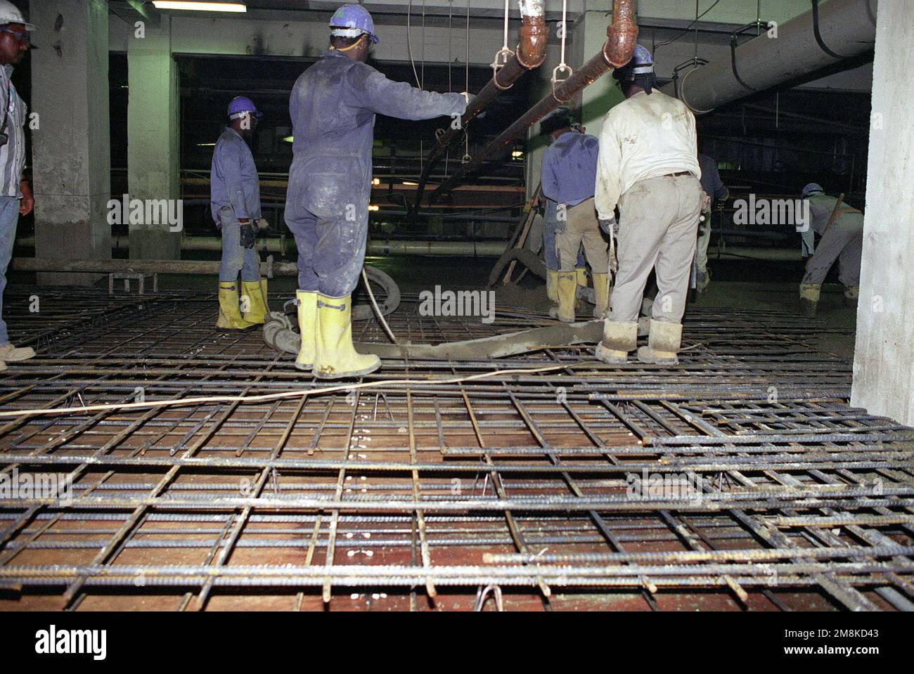 Renovation of the Pentagon building. Workers pouring concrete. Base ...