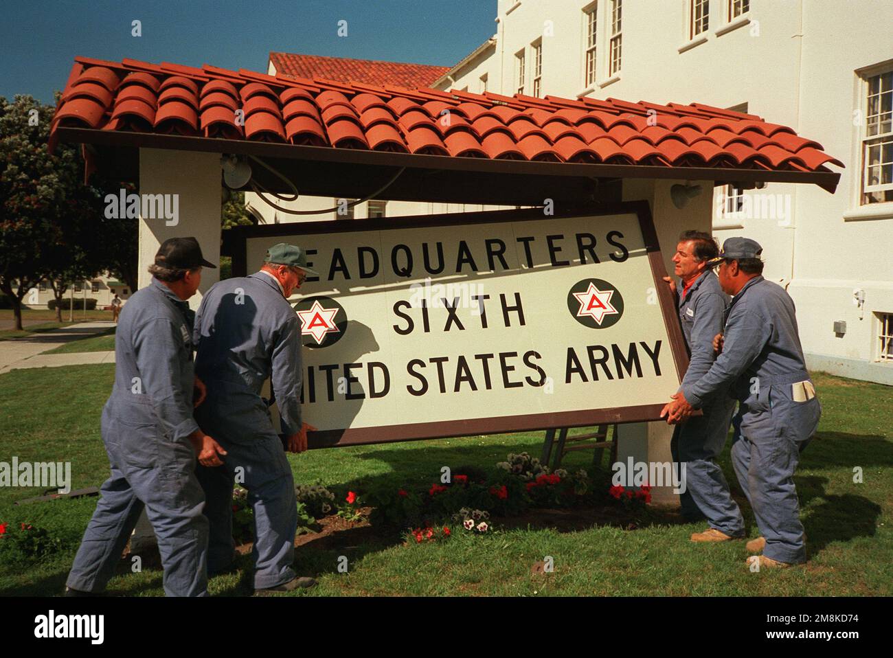 Workers removing the 6th US Army Headquarters Sign. Base: The Presidio ...
