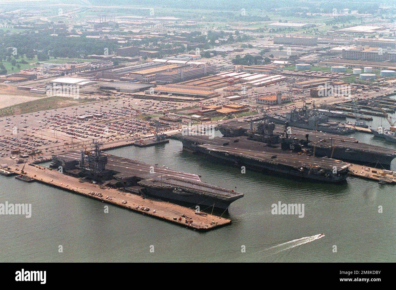 An aerial view looking east-southeast of piers 11 and 12 at the Naval ...