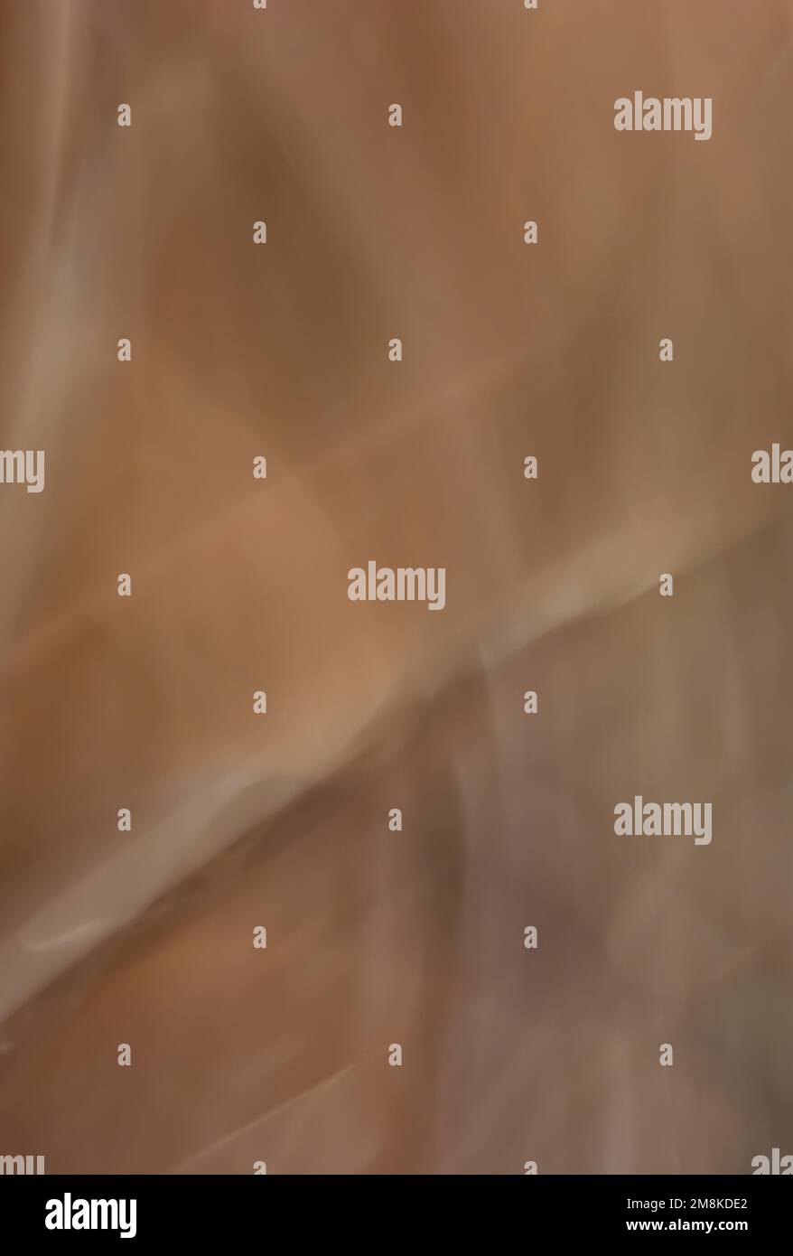 Abstract softly blurred brown crumpled cardboard background with folds ...