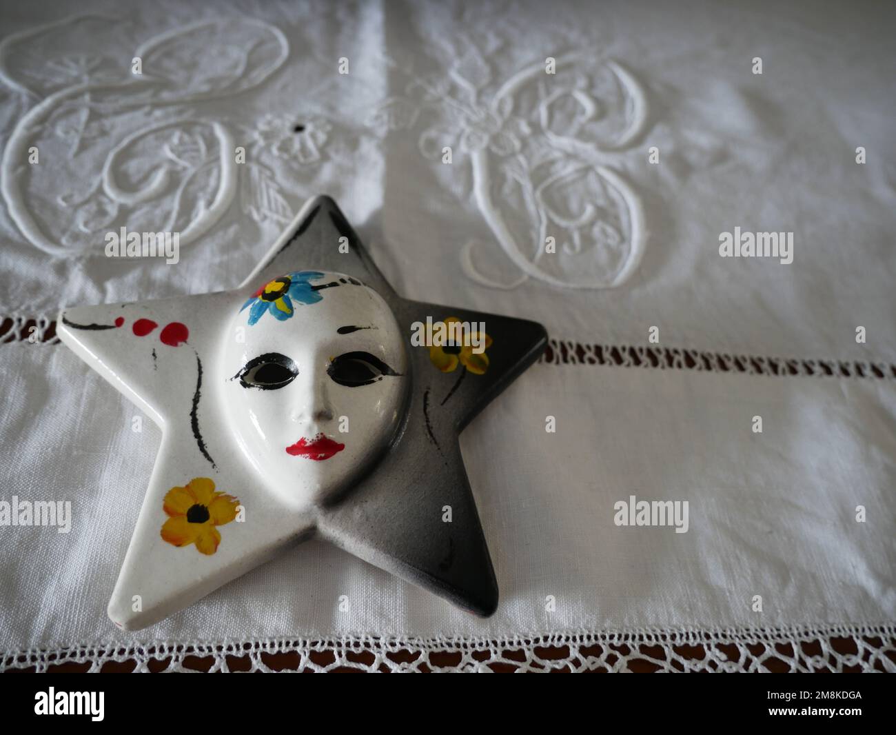 Small star-shaped Venetian mask hand painted on tablecloth from the ...