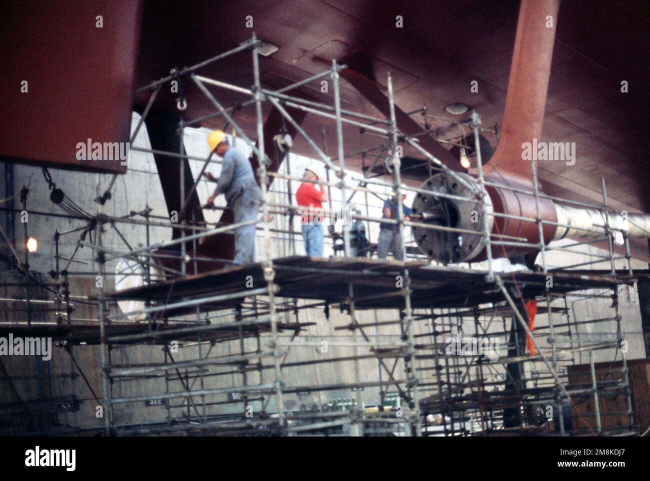 Shipyard workers reassemble the starboard shaft housing of the ...