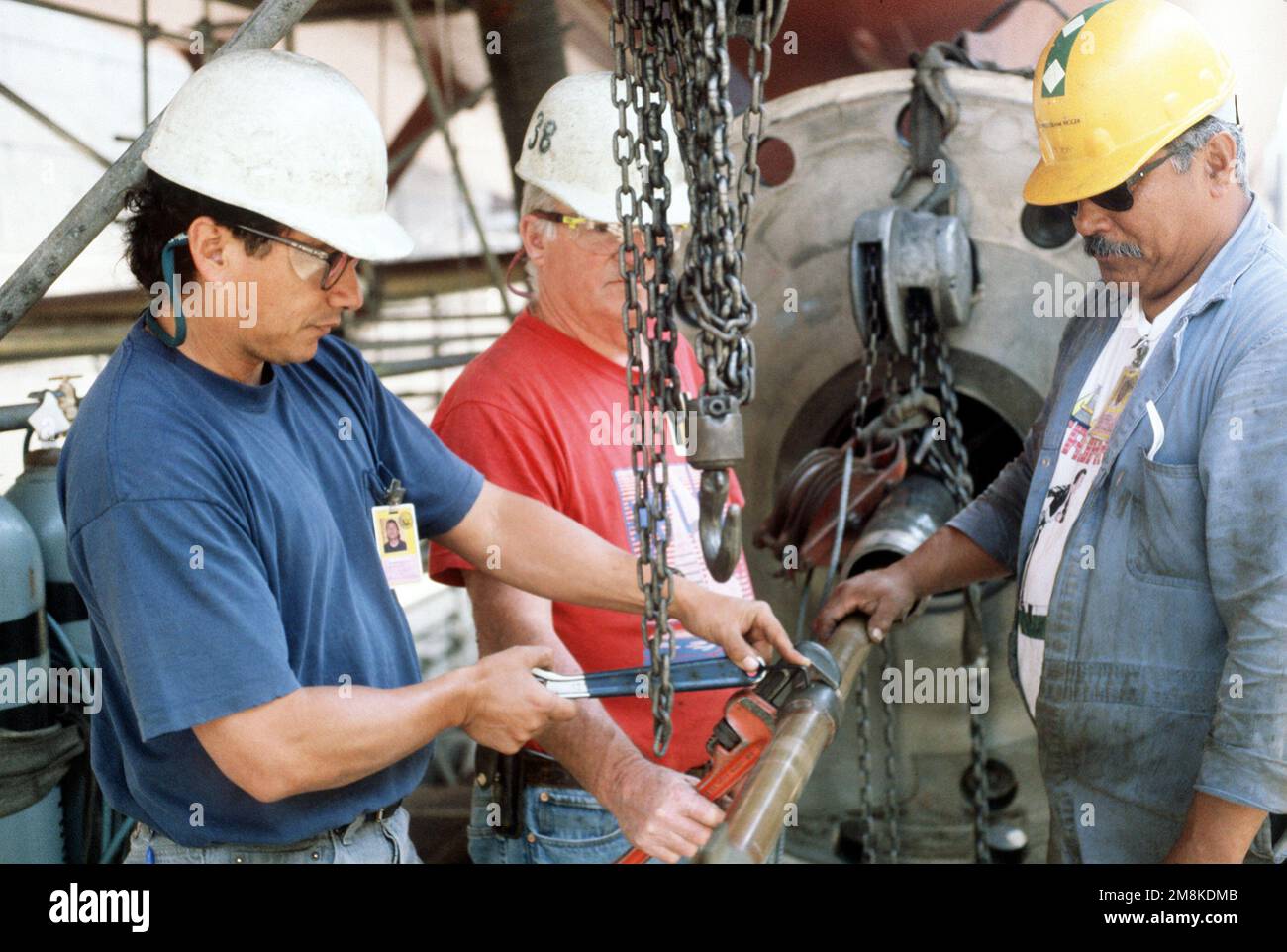 Shipyard workers reassemble the starboard shaft housing on the ...