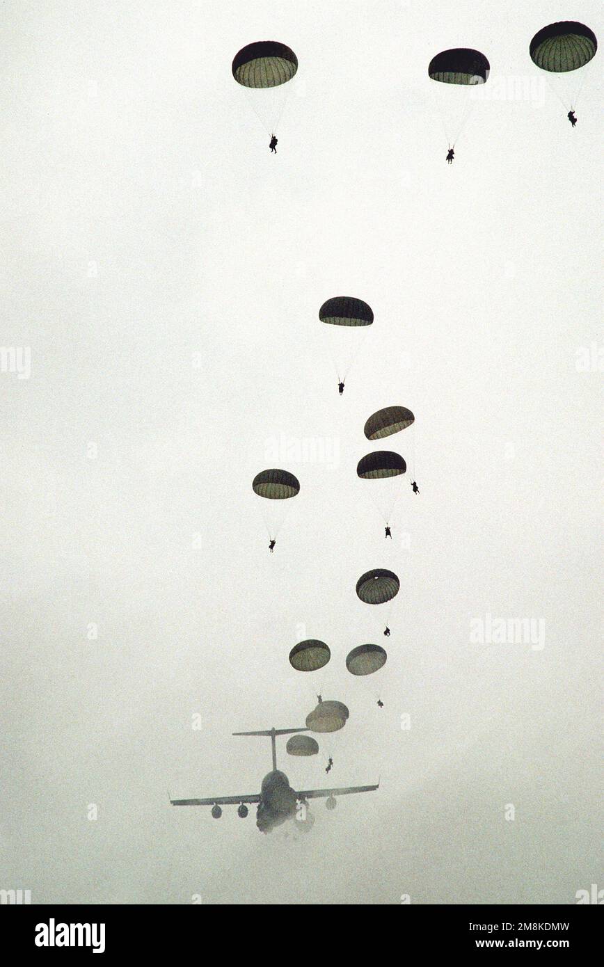 U.S. Army paratroopers from the 82nd Airborne Division parachute from a ...