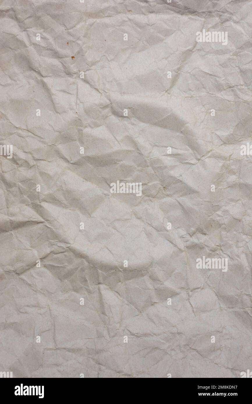 Vertical background from old crumpled paper, a circle is squeezed out ...