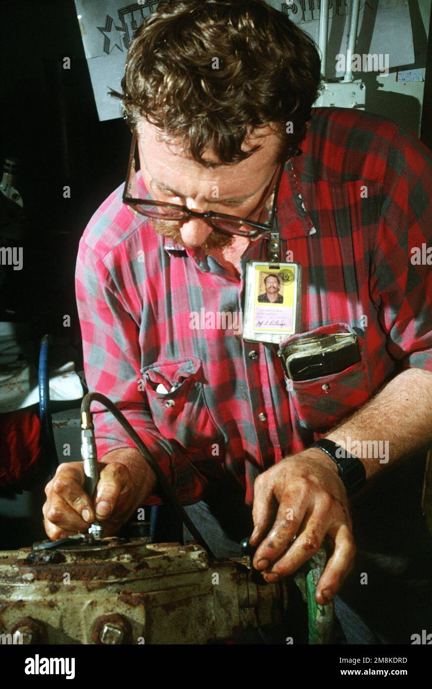 Jeff Rutledge works on valves for the firemain on the destroyer USS ...
