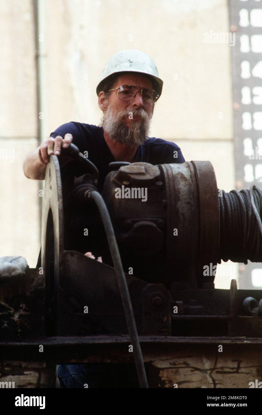 Dave Price operates a winch on the floor of drydock #3. Price is part ...