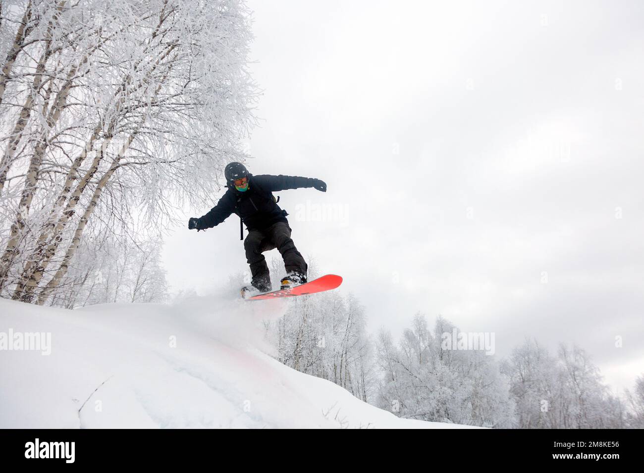 incredible snowboard jump under the white snowy forest in a good winter ...
