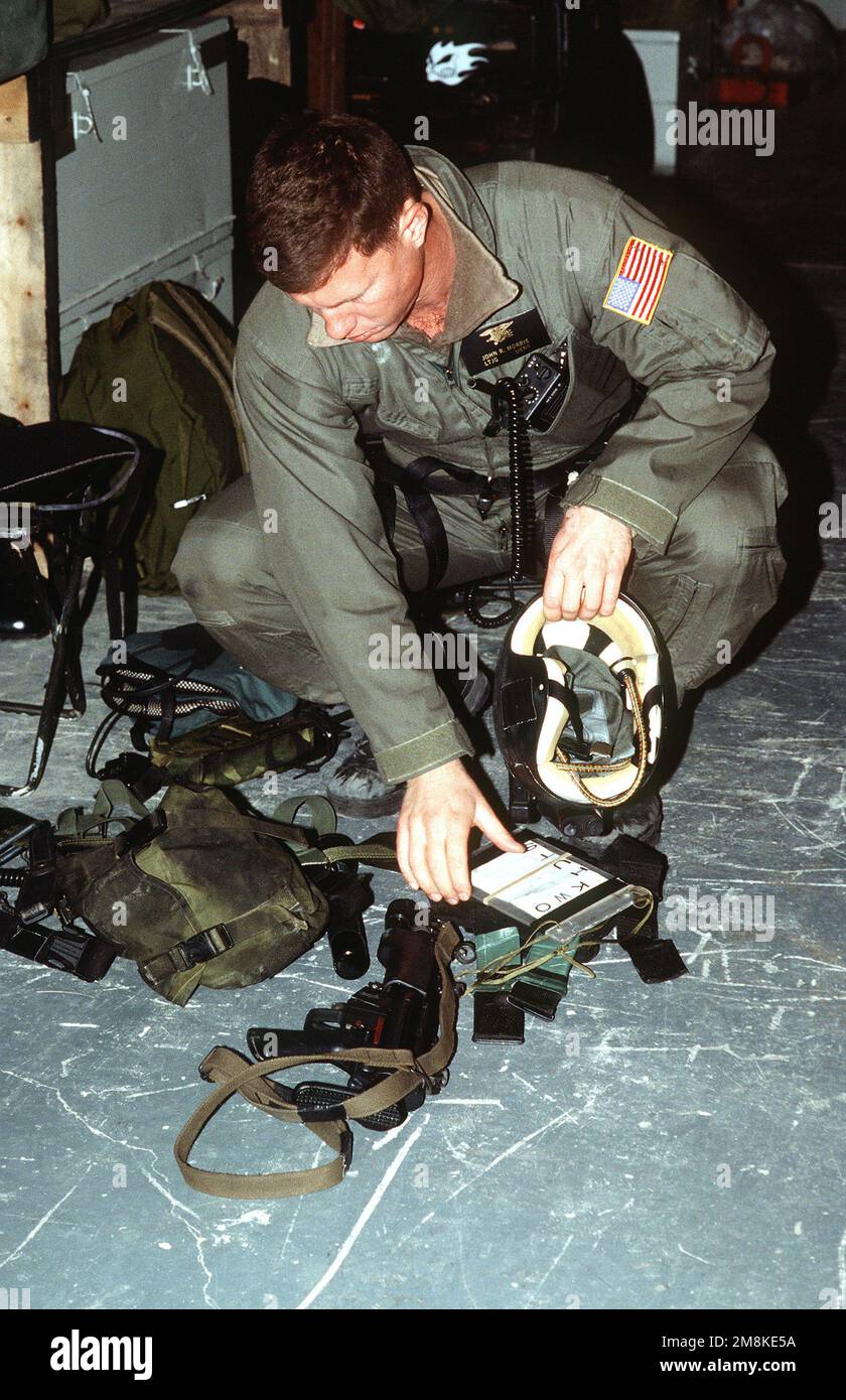 Lieutenant Junior Grade (LTJG) John Morris, US Navy SEAL, readies his ...