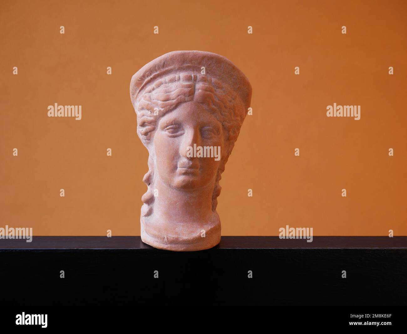 Scale reproduction on an orange background of the head of Hera or Juno ...