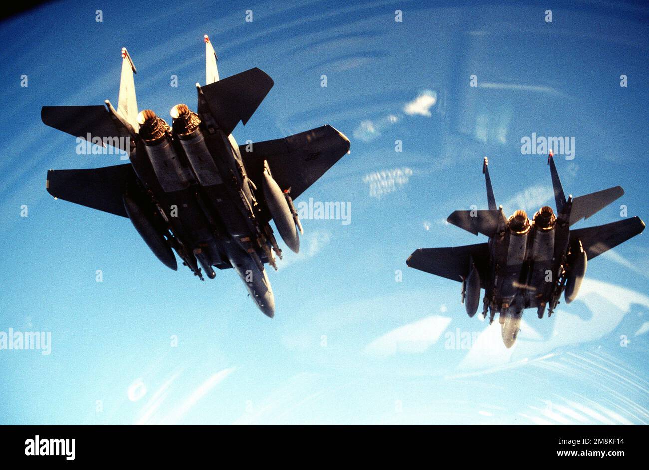 An air to air rear underside view of two US Air Force F-15E Strike ...