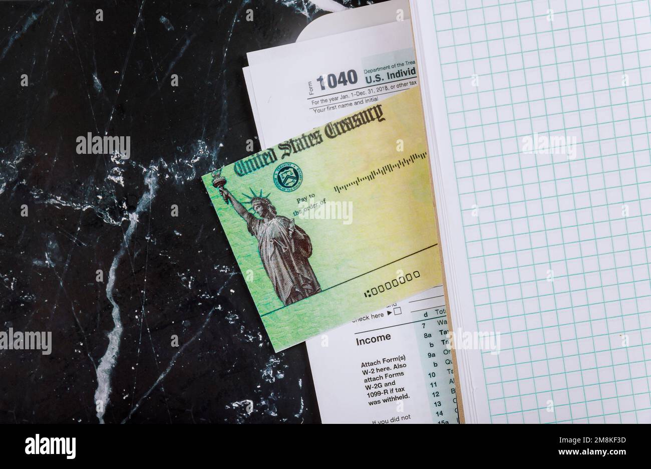 On desk 1040 individual income tax form, pen calculator, and dollar ...