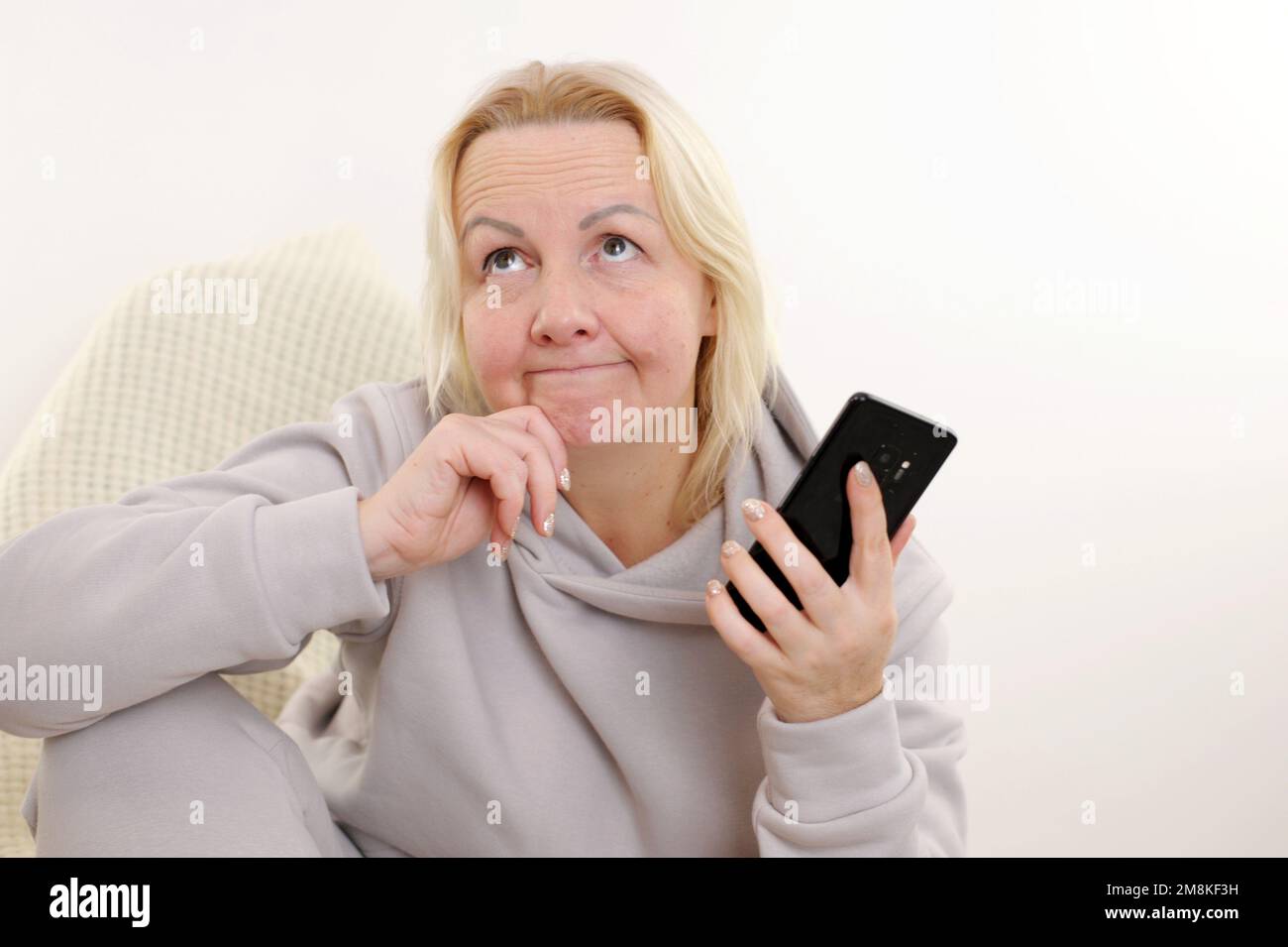 thinking dreaming beautiful woman posing using mobile phone Female ...