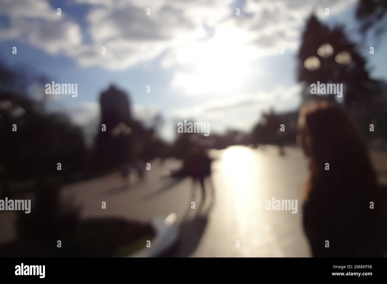 Blurred background of a city street and passing people. Sunny cool ...