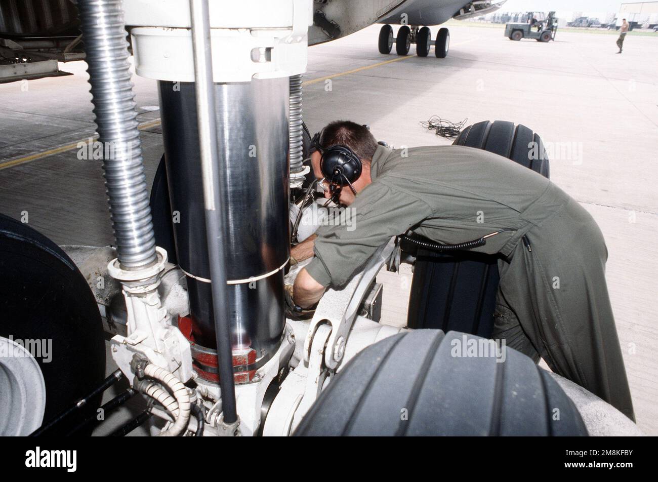 SSGT Jeff Schengler, crew chief, attaches kneeling collars to the ...
