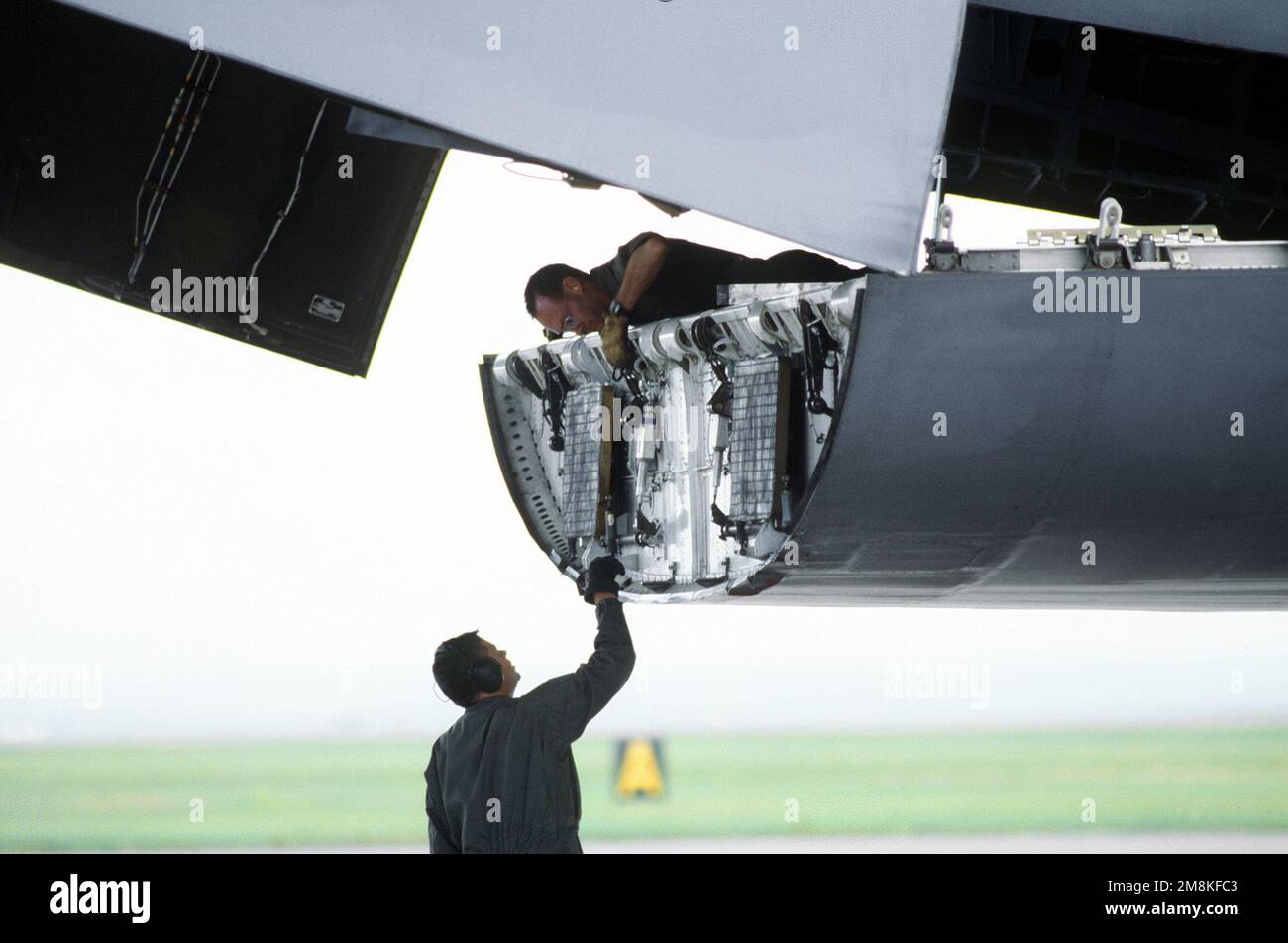 Load masters check the aft cargo ramp of the C-5B Galaxy from the 60th ...