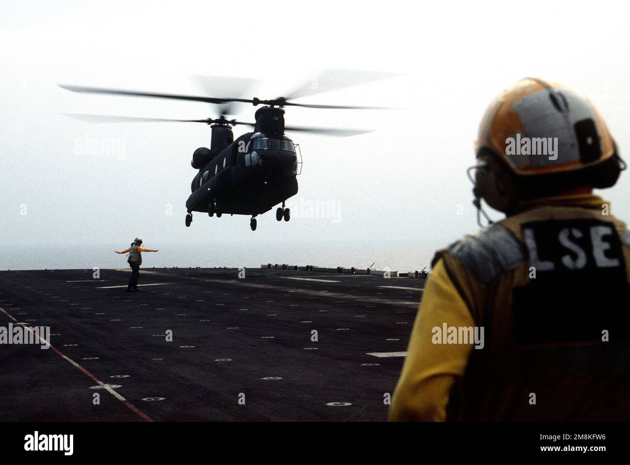 A US Army CH-47D Chinook helicopter makes an approach to the flight deck during deck landing ...