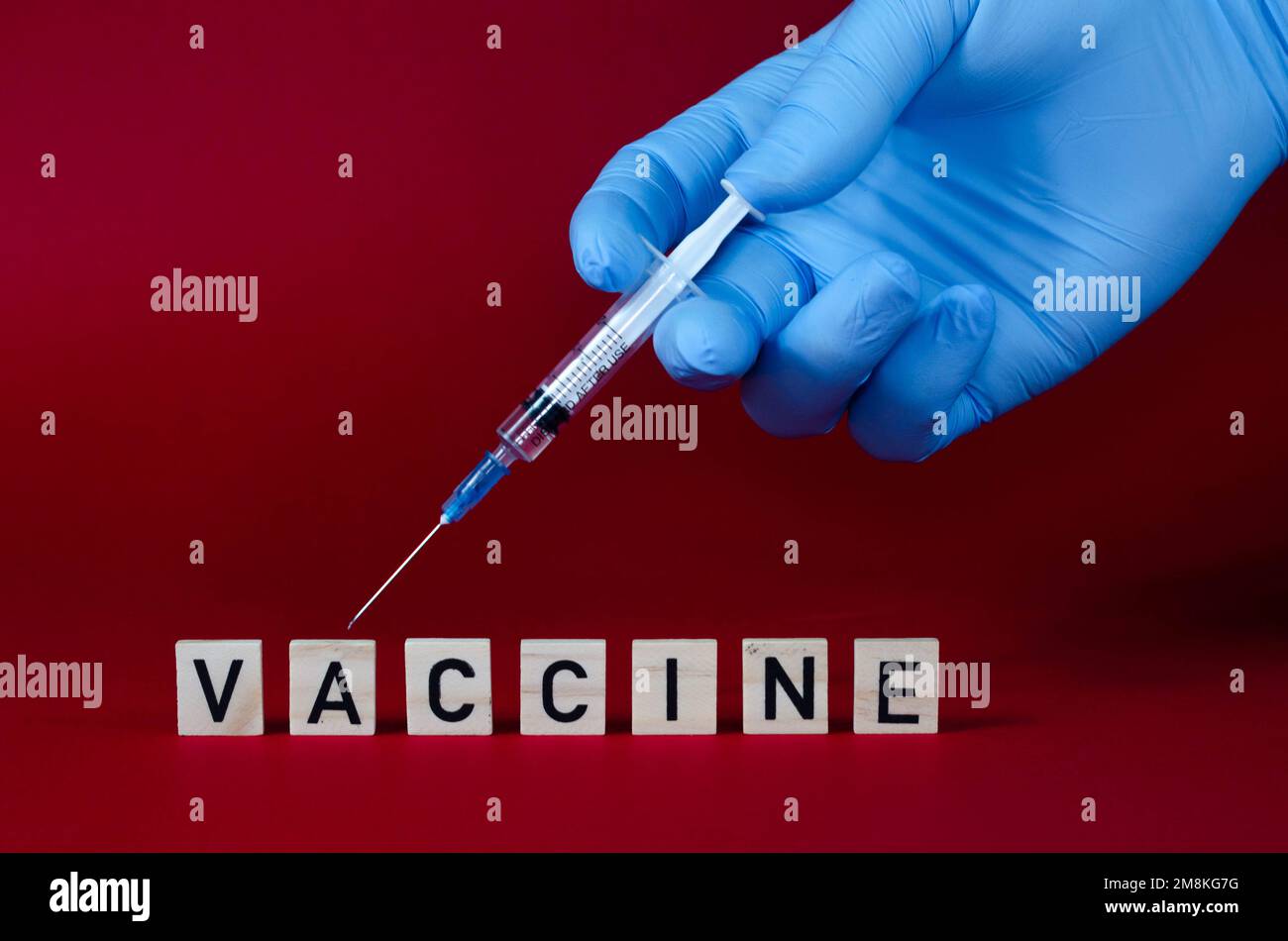 Doctor in blue latex gloves with syringe, close-up. Making a vaccine ...