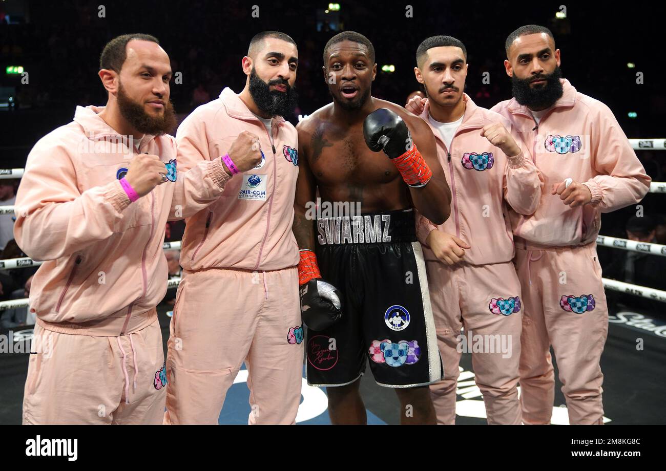 Swarmz (centre) celebrates winning the cruiserweight bout against Ryan ...