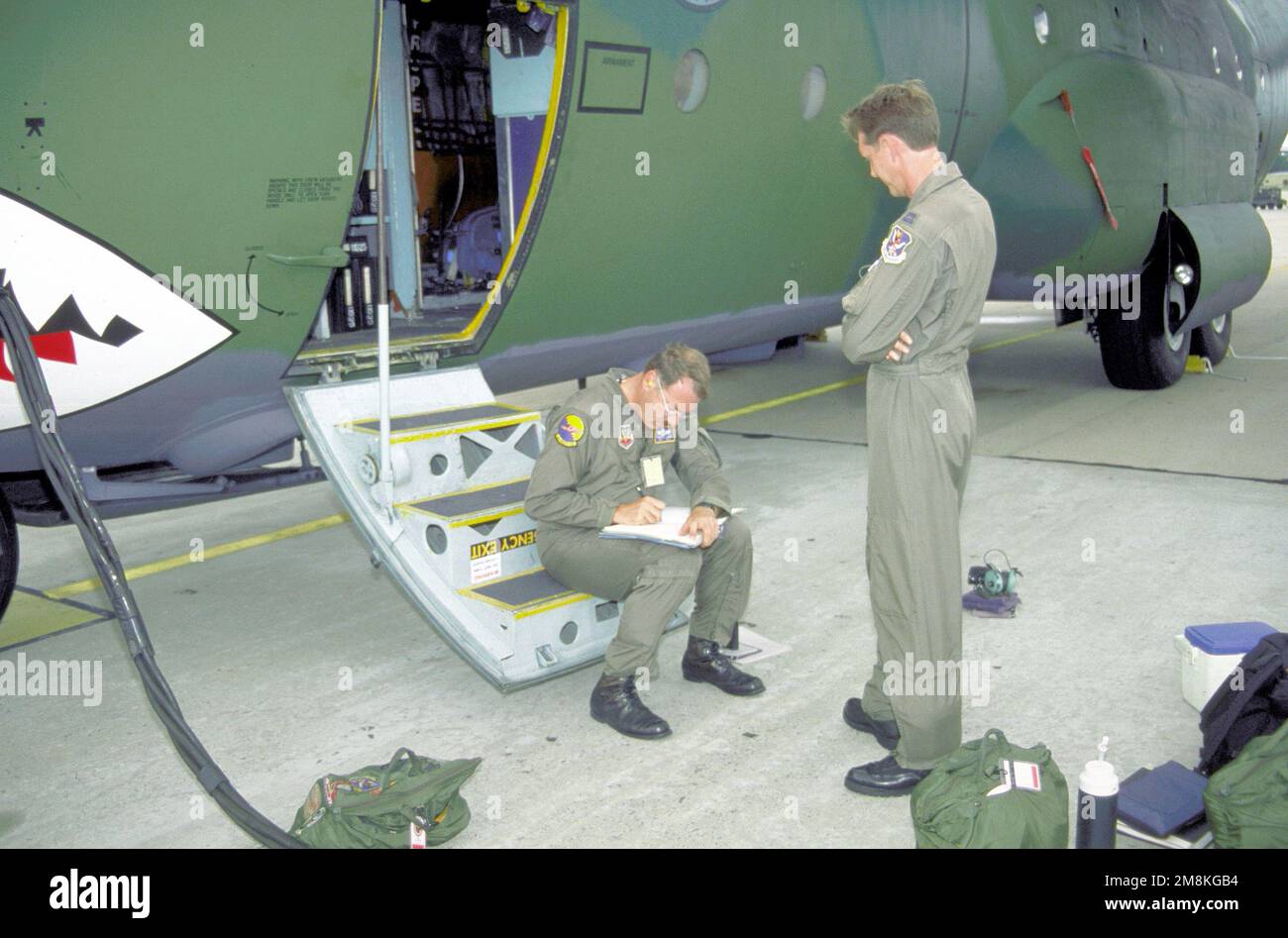 Inspectors MASTER SGT. Robert Horten (seated on the aircraft steps) and ...