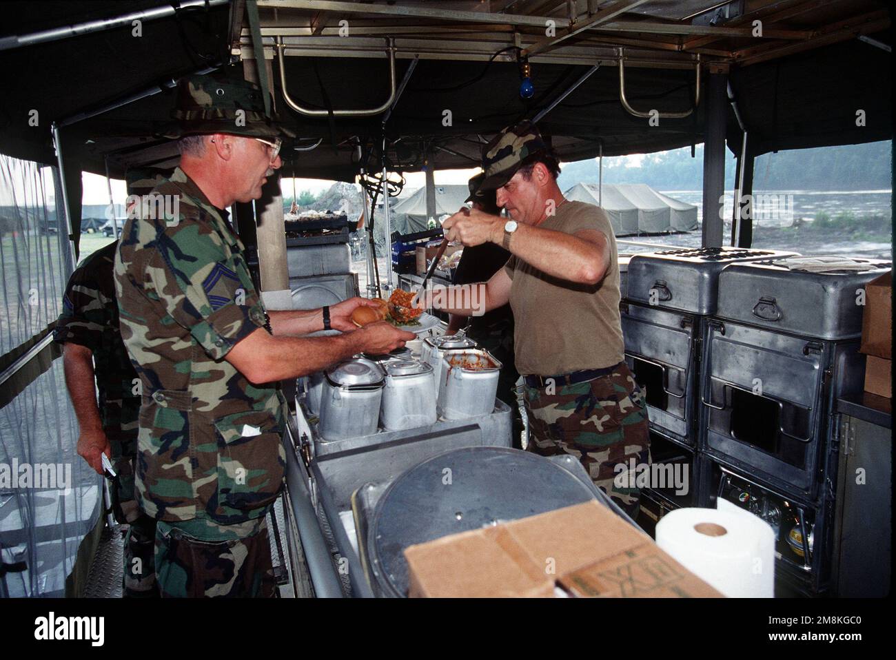 At the field kitchen serving line, Technical Sergeant Raymond Patterson ...
