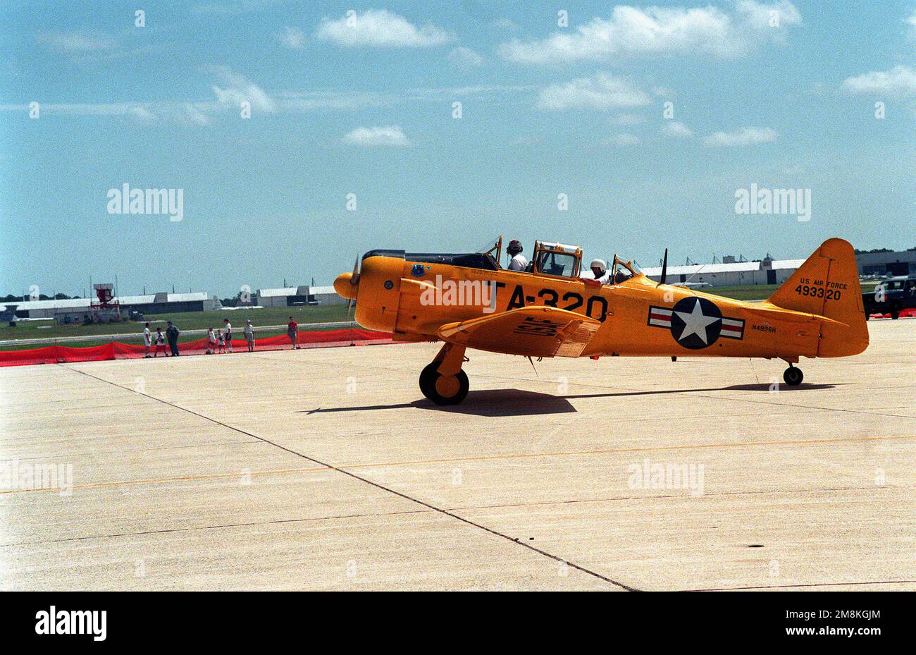 A right side view of an AT-6 Harvard aircraft taxiing across the south ...
