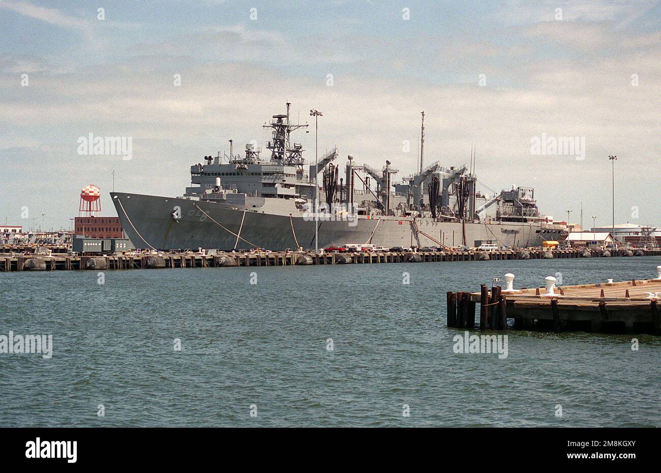 A port bow view of the fast combat support ship USS SUPPLY (AOE-6) tied ...