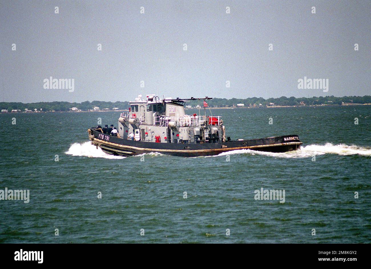 A port quarter view of the yard tug boat MARINETTE (YTB-791) underway ...