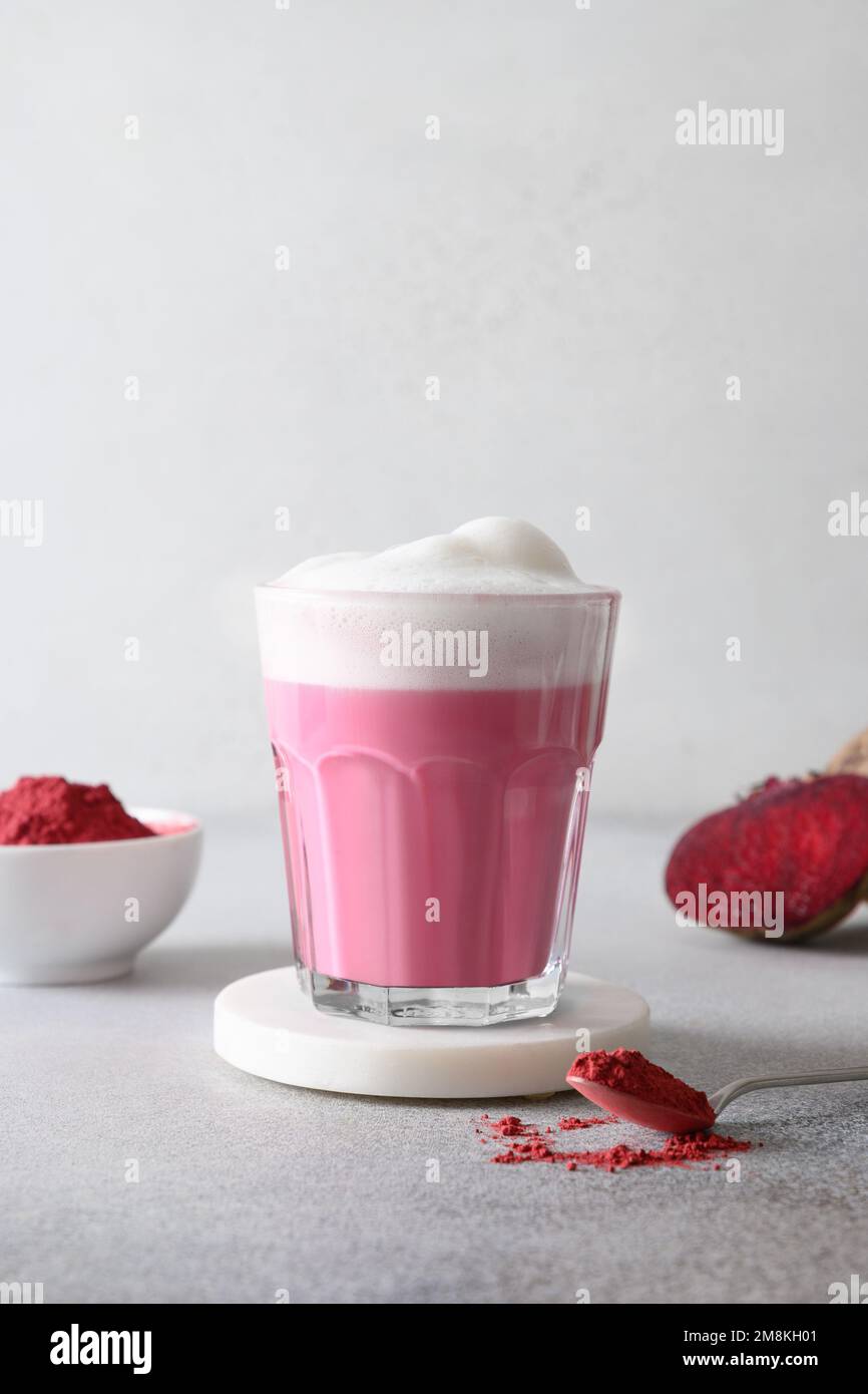 Beetroot latte or pink moon milk latte of beetroot powder in glass on ...