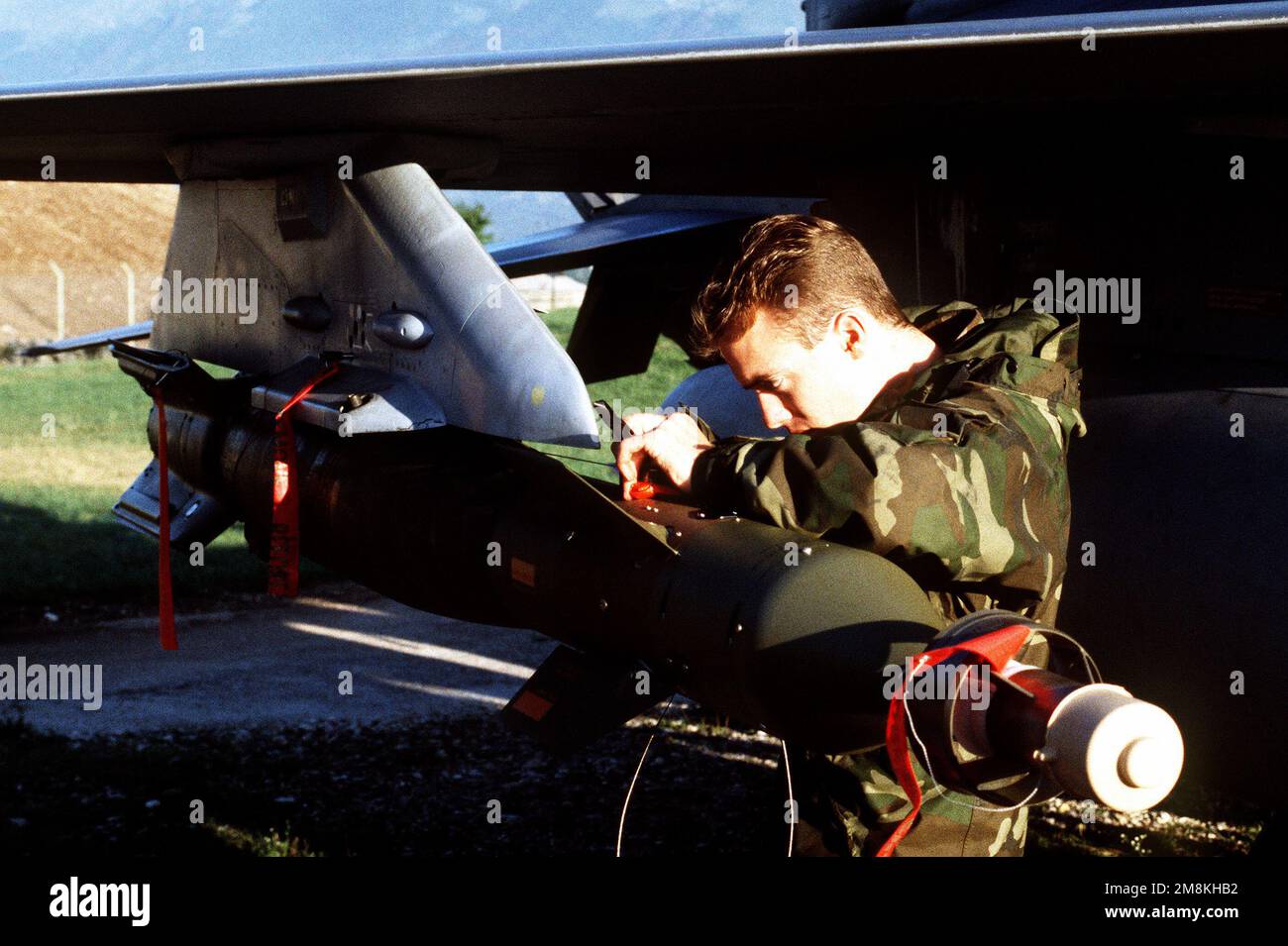 US Air Forces weapon loaders load an AGM-123 Skipper air to surface ...