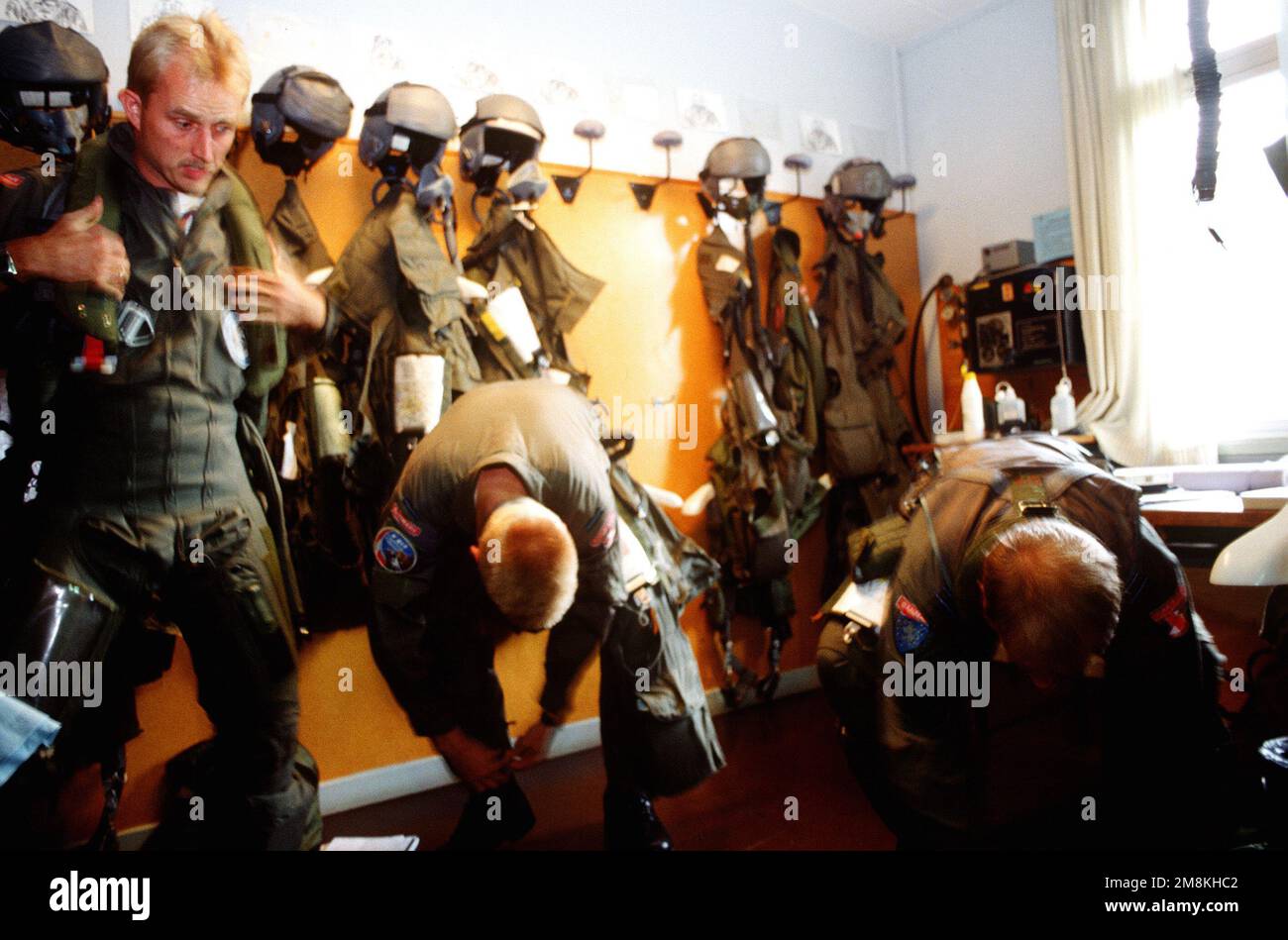 Danish F-16 pilots prepare for flight by dressing in essential life ...