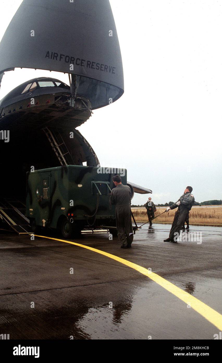 Air Force personnel offload equipment at Flyvestation. Personnel and ...