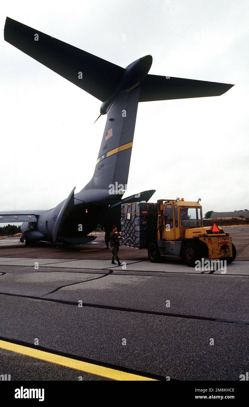 Air Force personnel offload equipment at Flyvestation. Personnel and ...